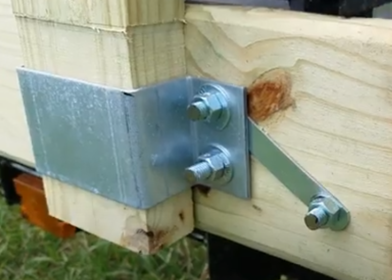 Adding custom wood stake walls to the outside of a cheap utility ...